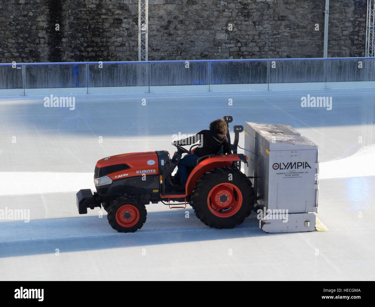 cleaning clearing ice rink tractor hopper crisp Stock Photo - Alamy