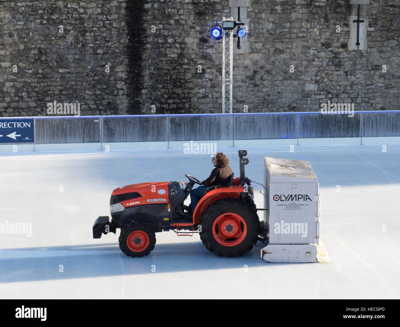 cleaning clearing ice rink tractor hopper crisp Stock Photo - Alamy