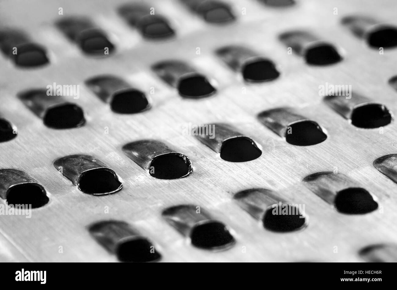 Close up abstract view of a stainless steel cheese grater showing the ...