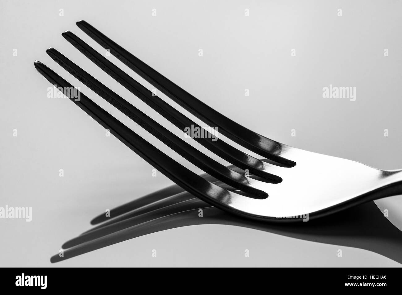 Dining fork reflecting on a shiny surface Stock Photo - Alamy