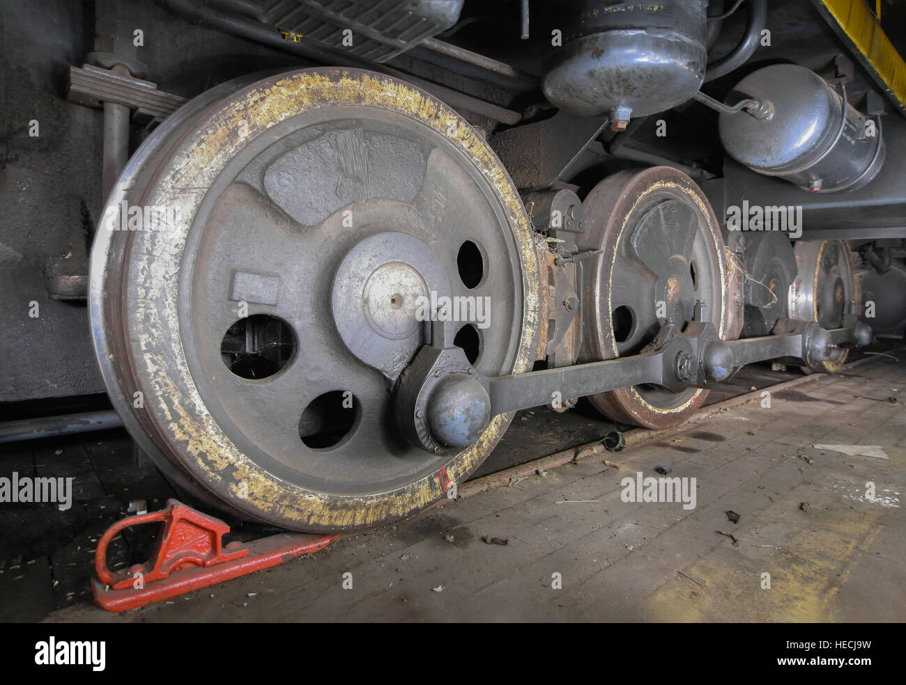 Wheels of the diesel locomotive close up. Red stop block Stock Photo ...