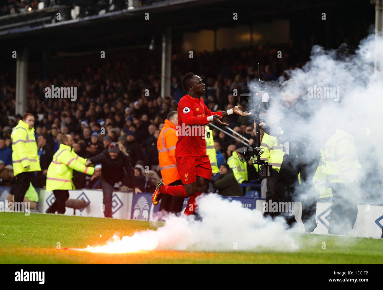 A flare is thrown onto the pitch as Liverpool's Sadio Mane celebrates ...