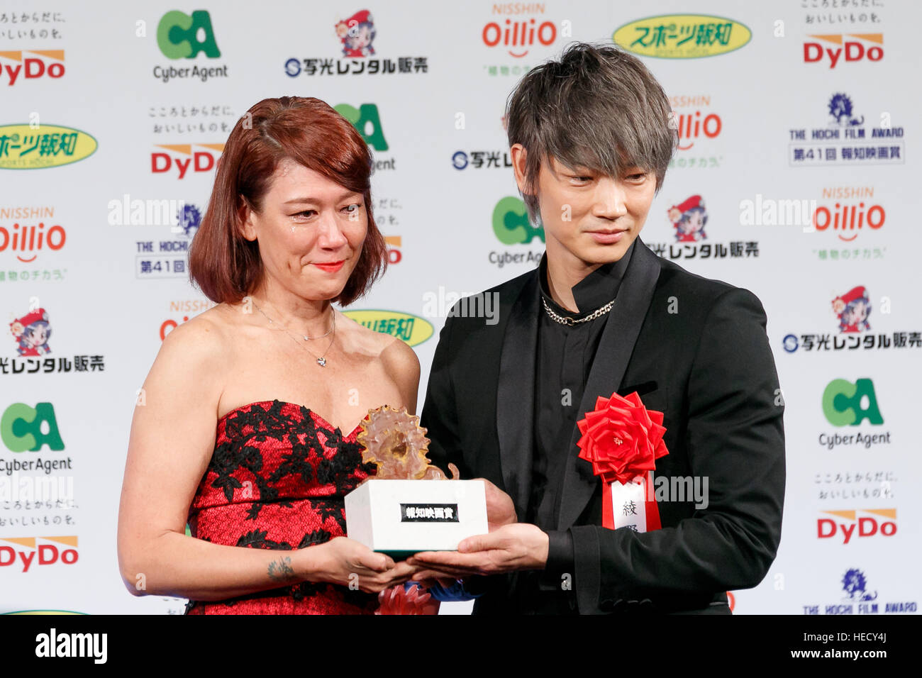 Actor Go Ayano (R) receives the Best Supporting Actor award during the ...