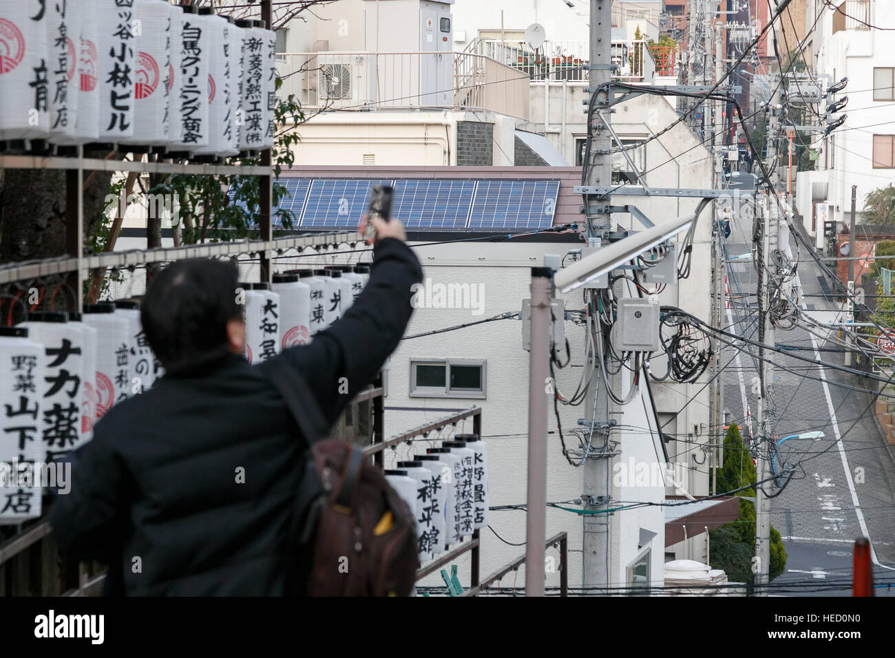 A man takes a pictures of the stairway next to Suga Shrine on December ...