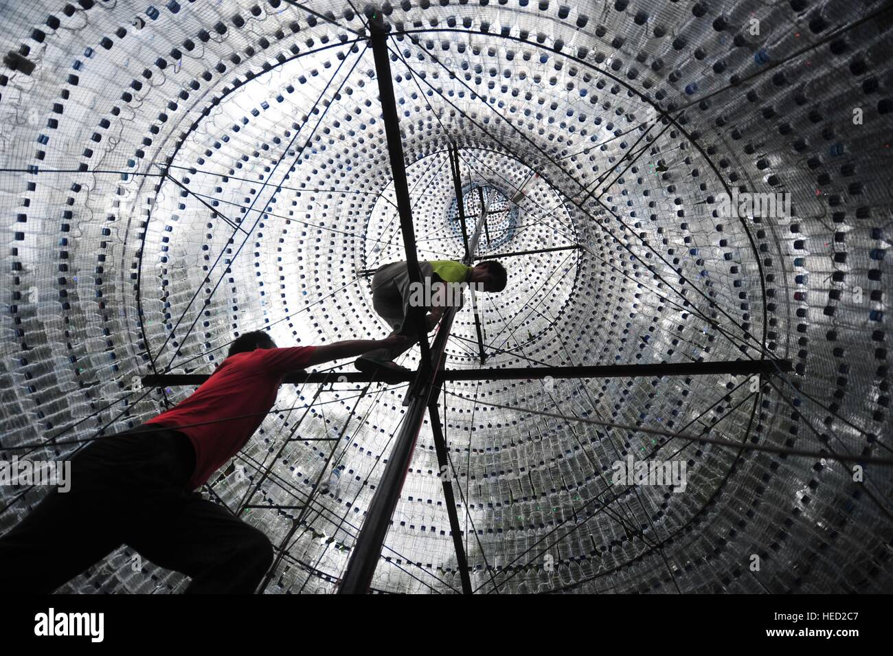 West Java, Indonesia. 21st Dec, 2016. Workers climb a Christmas tree in ...