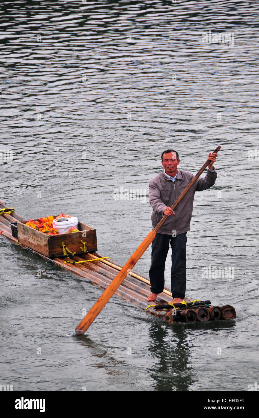 A bamboo raft guide paddles the Lijiang River Guilin-Yangshuo selling ...