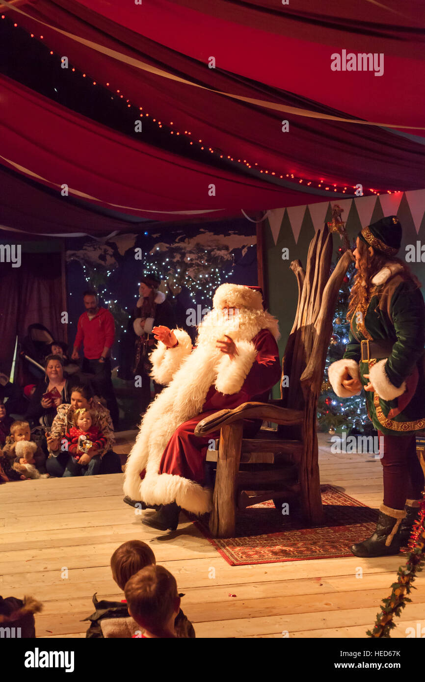 Father Christmas also known as Santa Claus entertaining children and ...