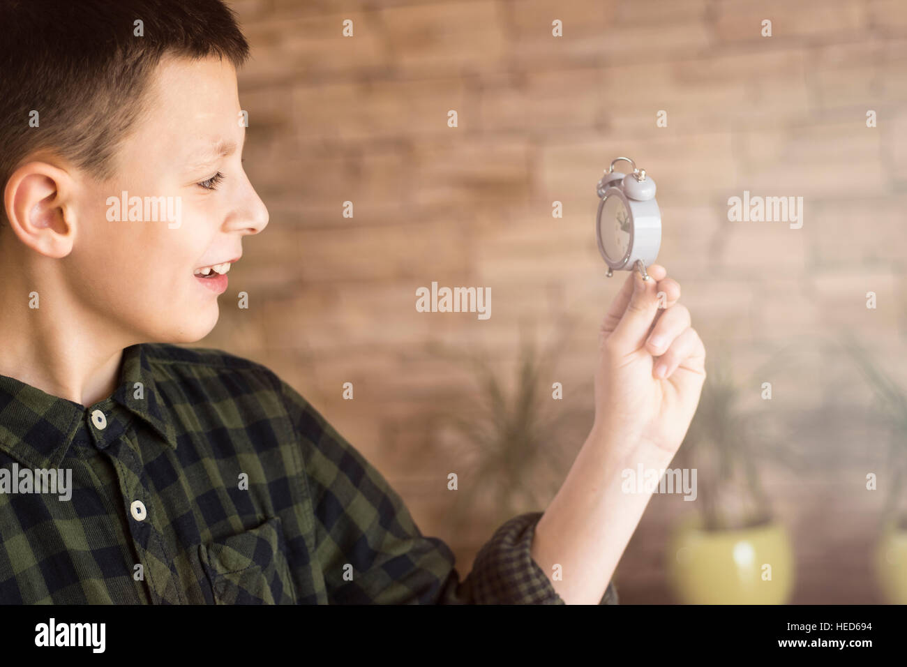 Young Boy Looking at the Small Clock and Smiling. Time Management ...