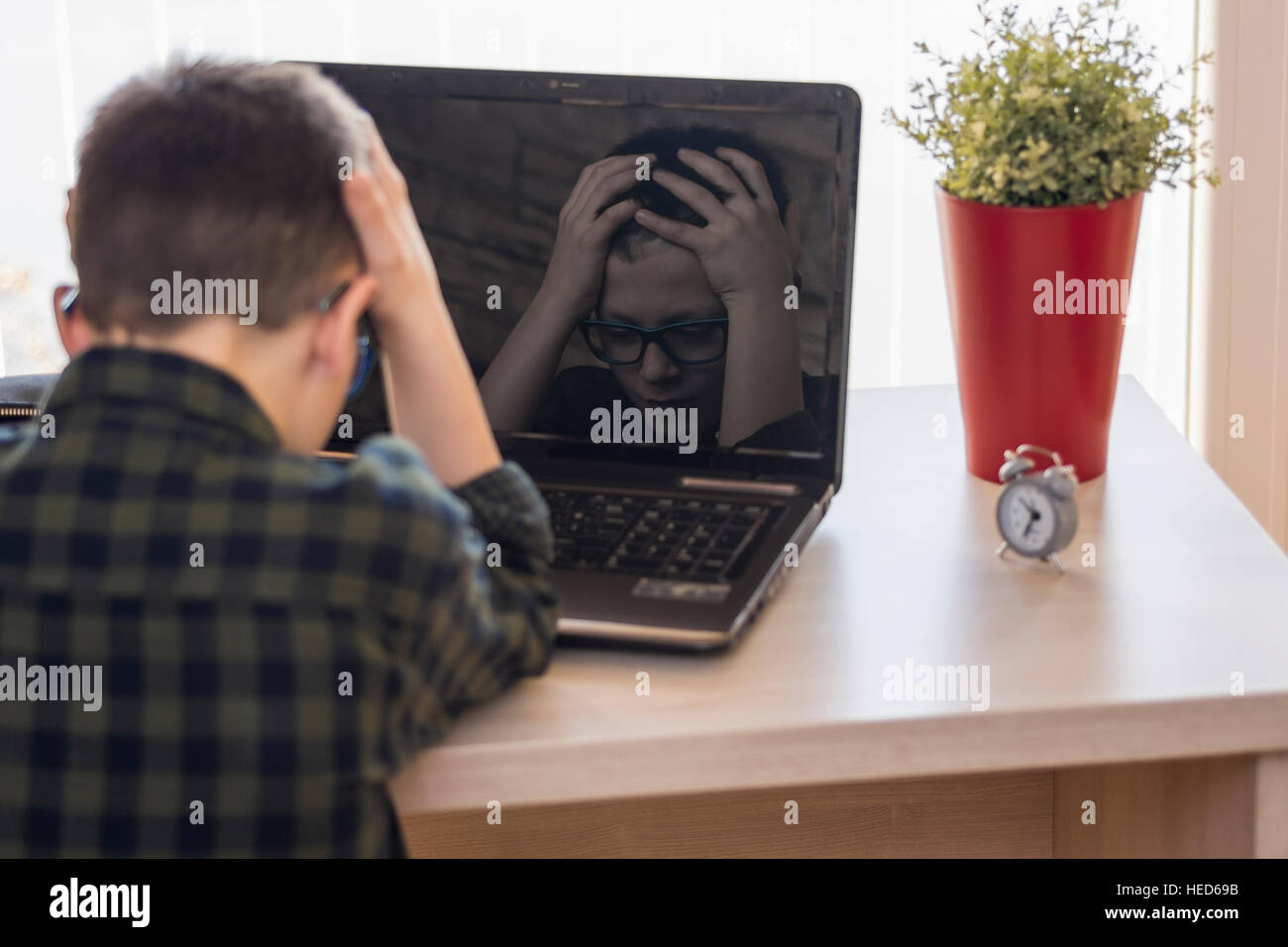 Shocked Boy With Glasses Using Laptop Computer While Sitting on Desk at ...
