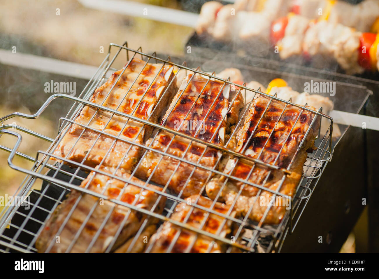 Meat skewers being grilled in a barbecue Stock Photo - Alamy