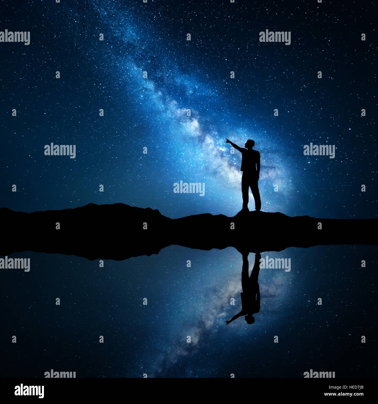 Milky Way. Silhouette of a man pointing finger in night starry sky on ...