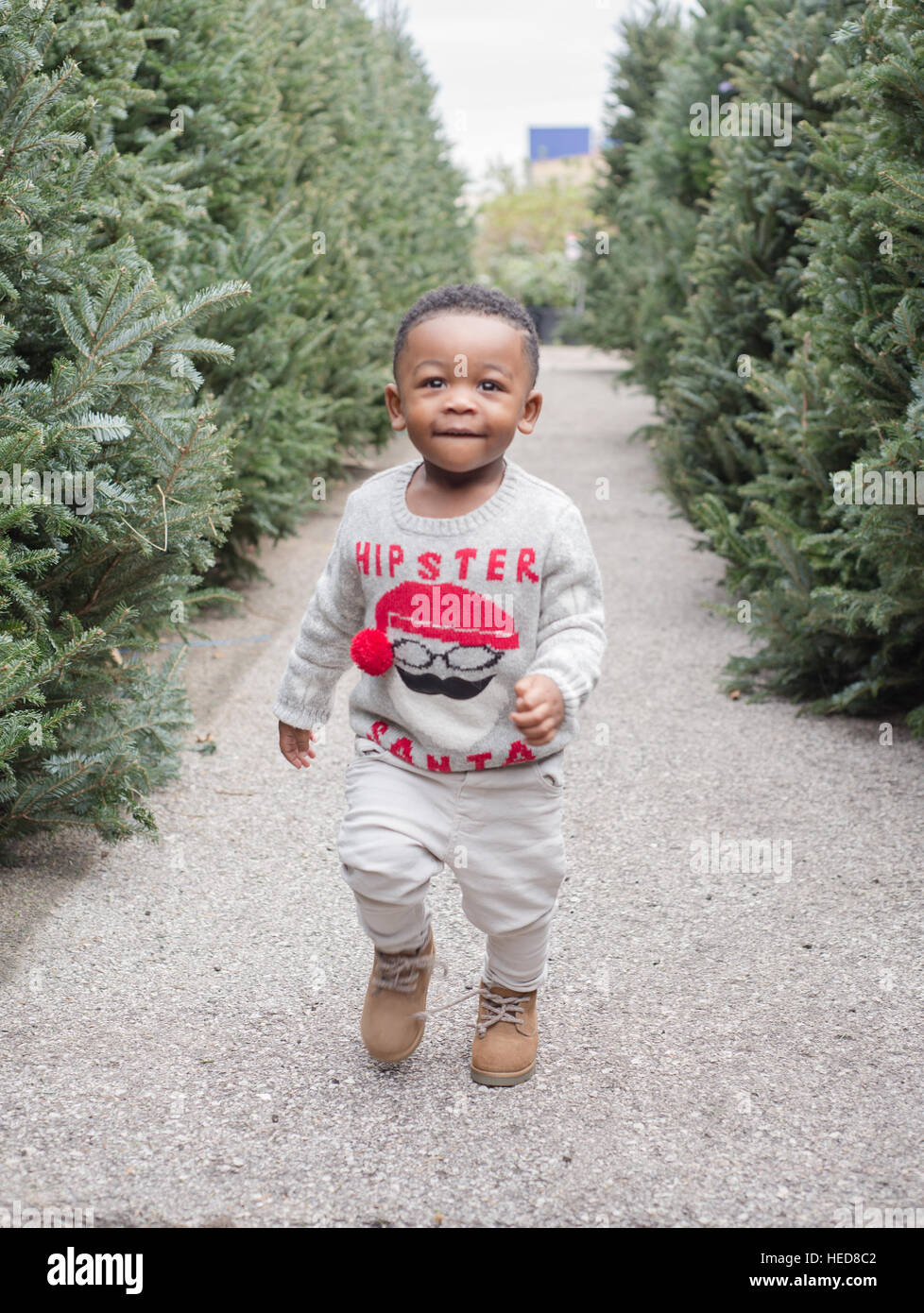 Boy running and smiling Stock Photo - Alamy