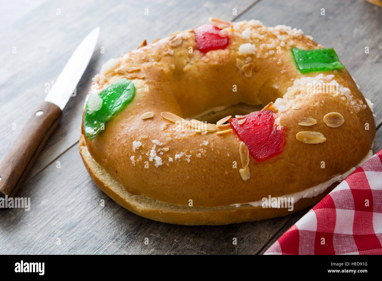 Spanish typical epiphany cake "Roscon de Reyes", on wooden background ...
