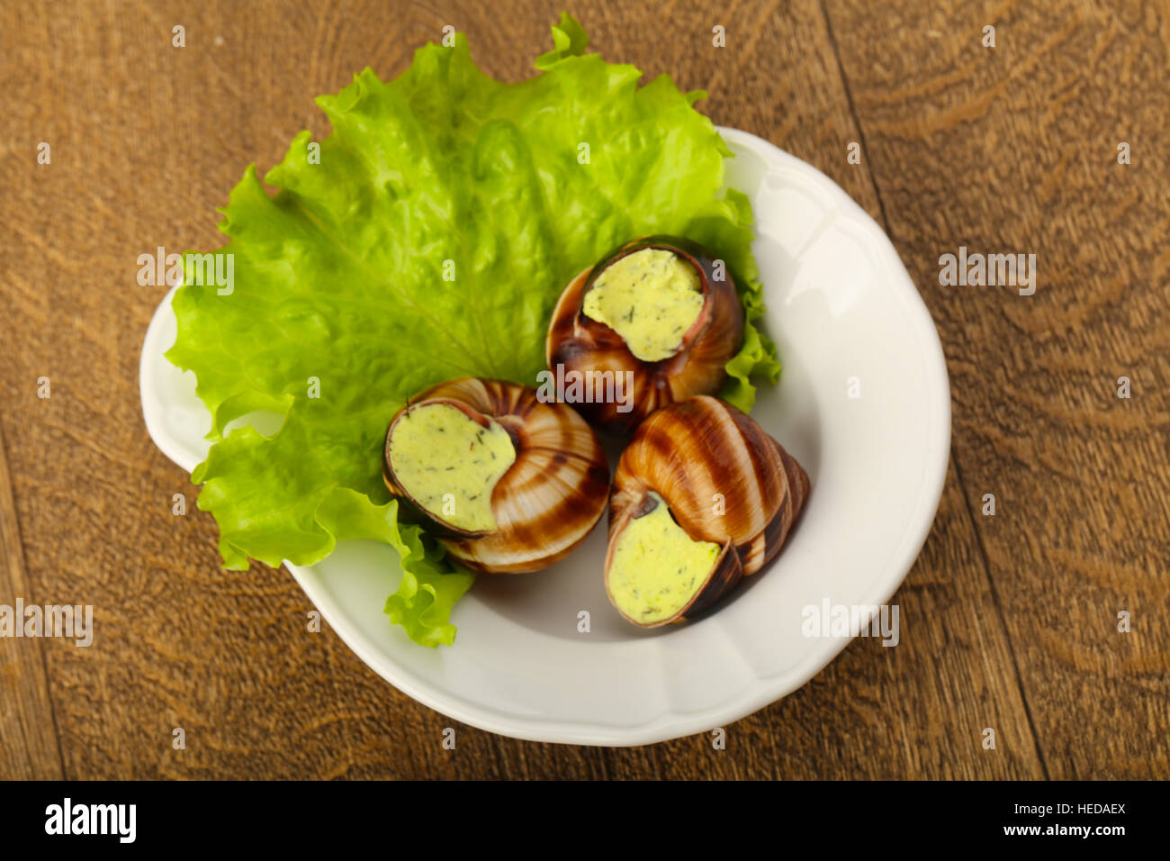 Escargot with cheese cream on salad leaves Stock Photo - Alamy