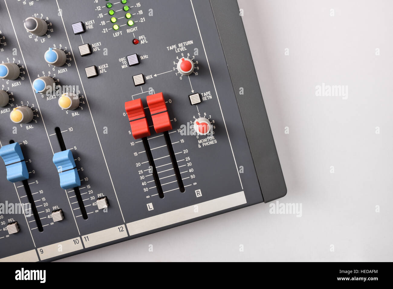 Buttons close up sound mixer on white table. Top view. Horizontal ...