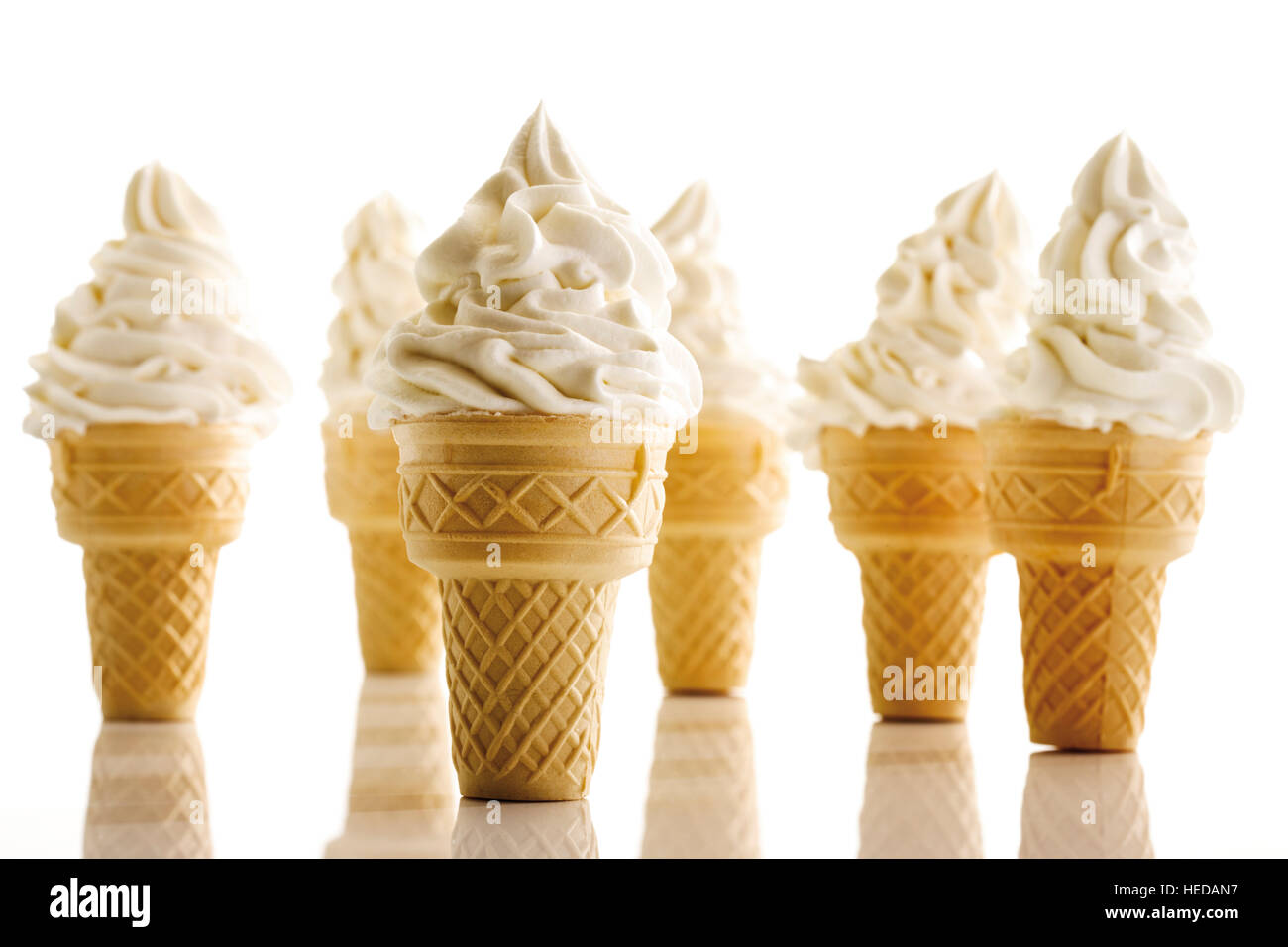 Numerous ice-cream cones filled with vanilla soft-serve Stock Photo - Alamy