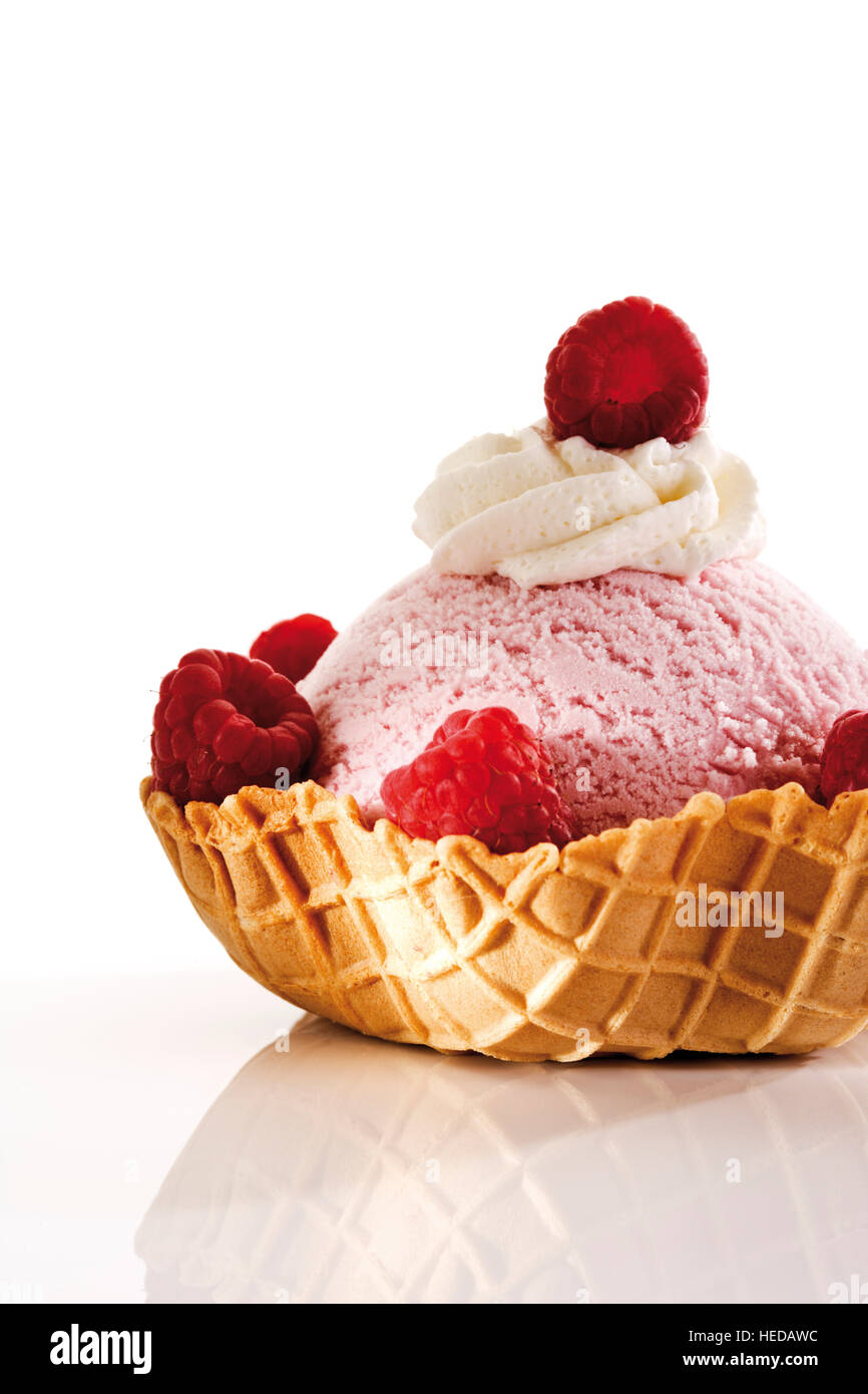 Raspberry ice cream, whipped cream and raspberries in a wafer bowl ...