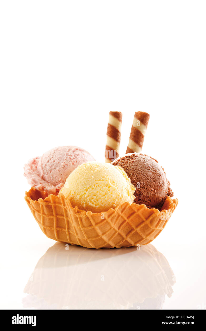 Strawberry, vanilla and chocolate ice cream and wafer rolls in a wafer ...