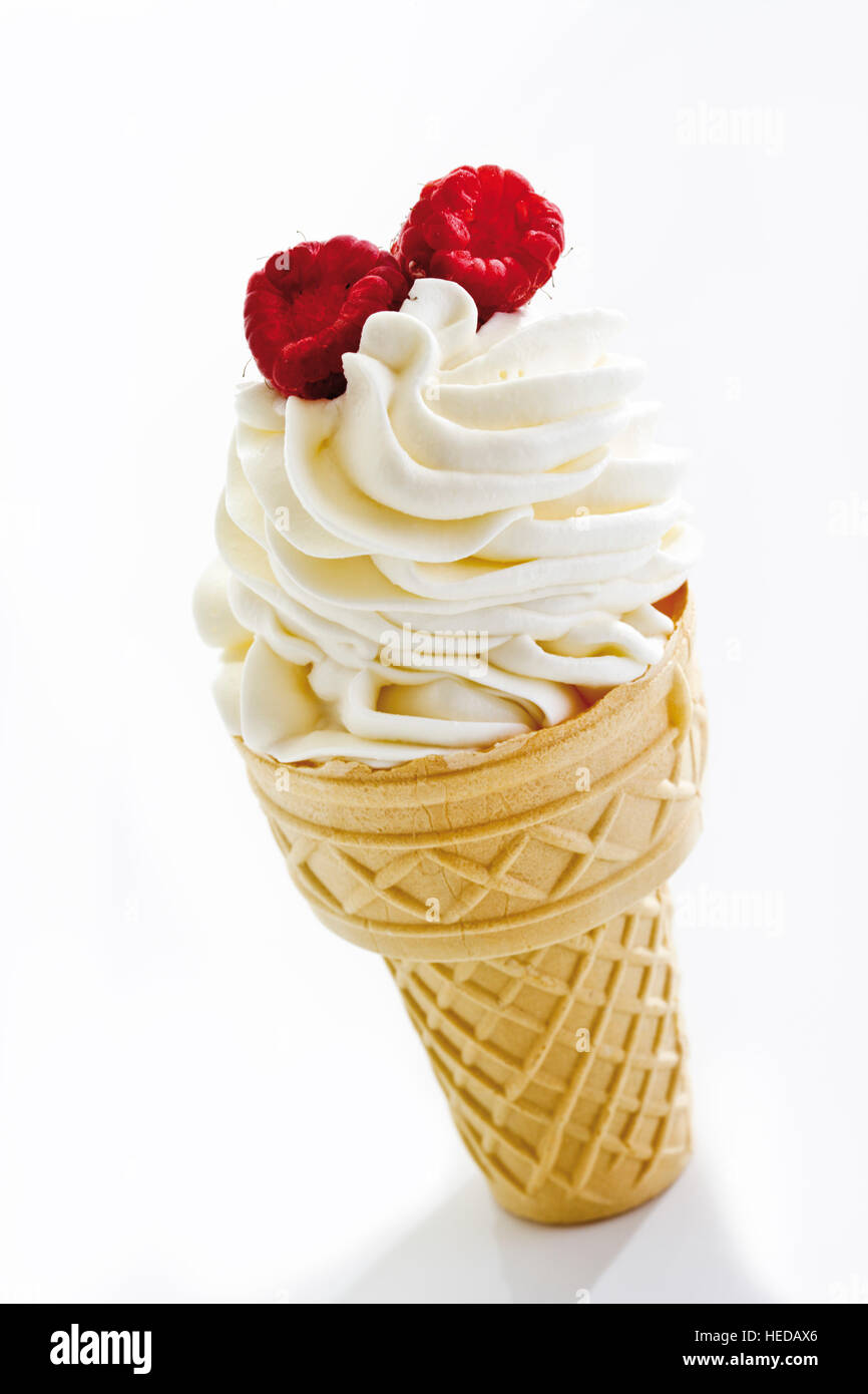 Soft serve ice cream cone and raspberries Stock Photo - Alamy