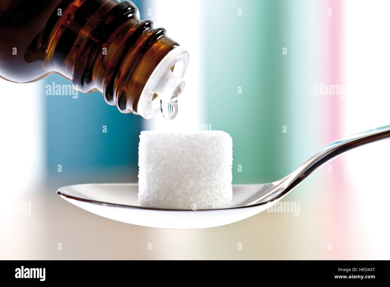 Homeopathic drops, sugar cube on a spoon Stock Photo - Alamy
