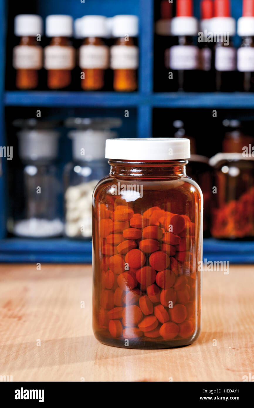 Pill bottle with screw top in front of an apothecary cabinet Stock ...