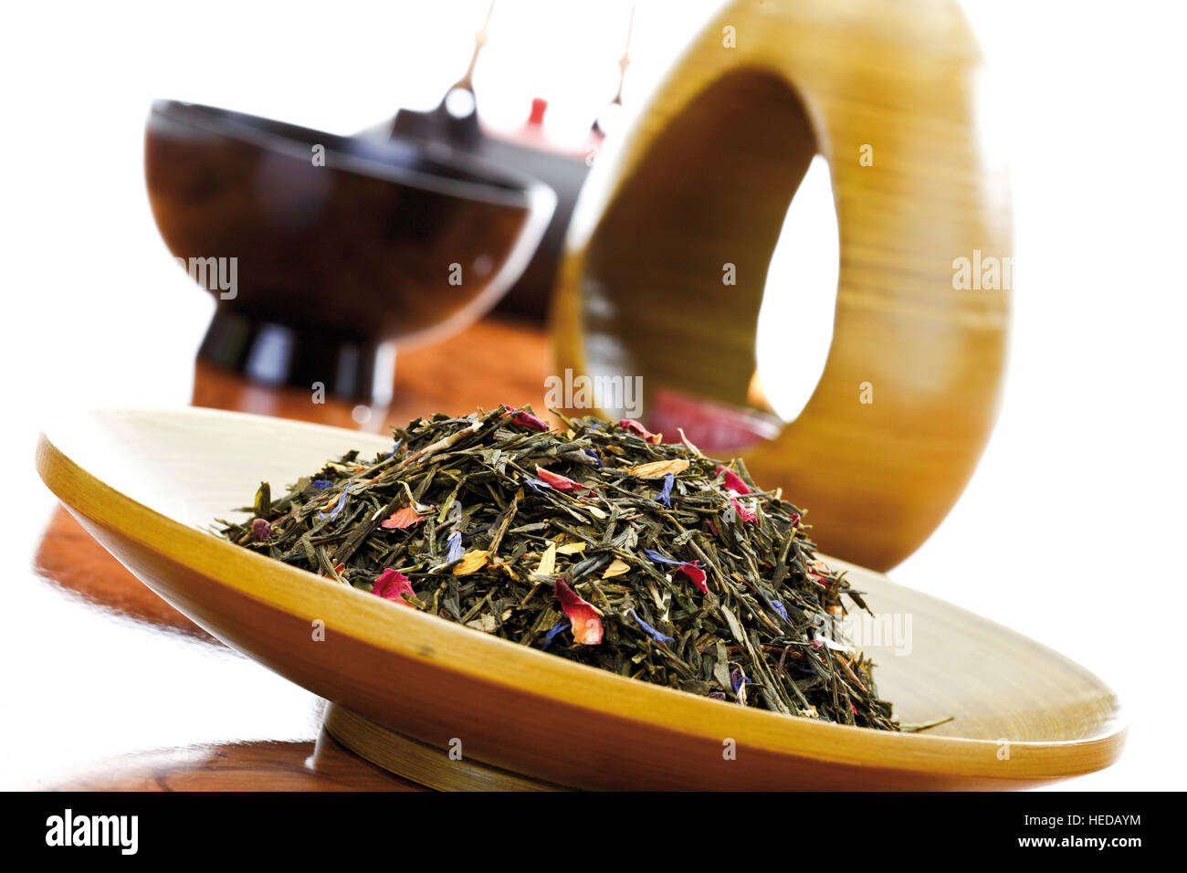 Green tea mixture in a wooden bowl and an Asian tea set Stock Photo - Alamy