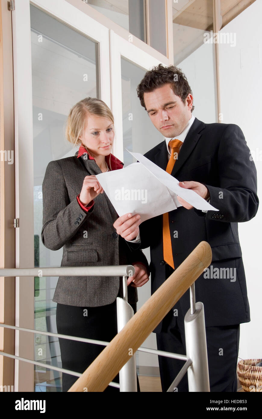 Two young businesspeople looking over documents Stock Photo - Alamy