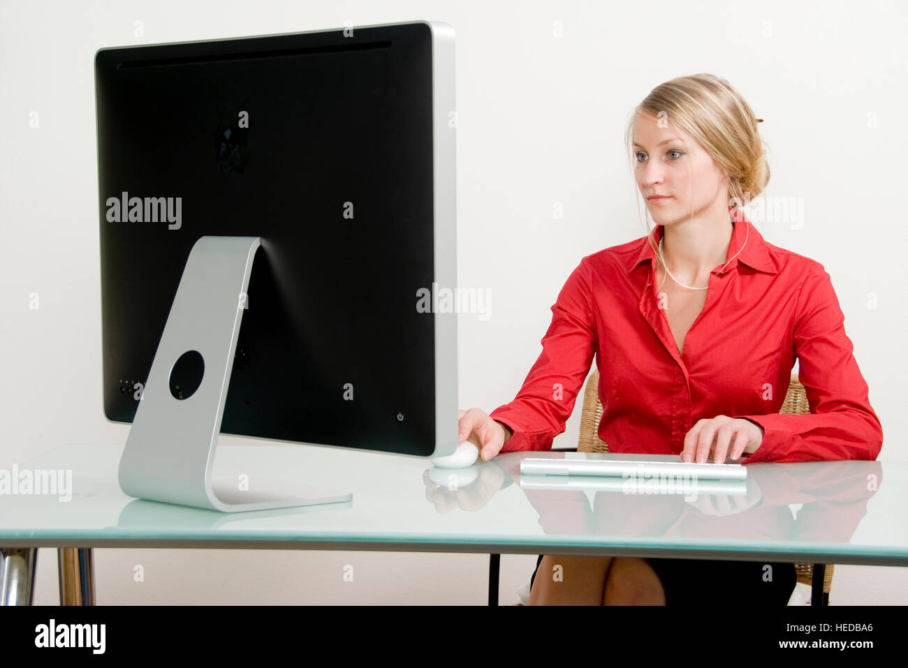 Young woman working on the computer at her desk Stock Photo - Alamy