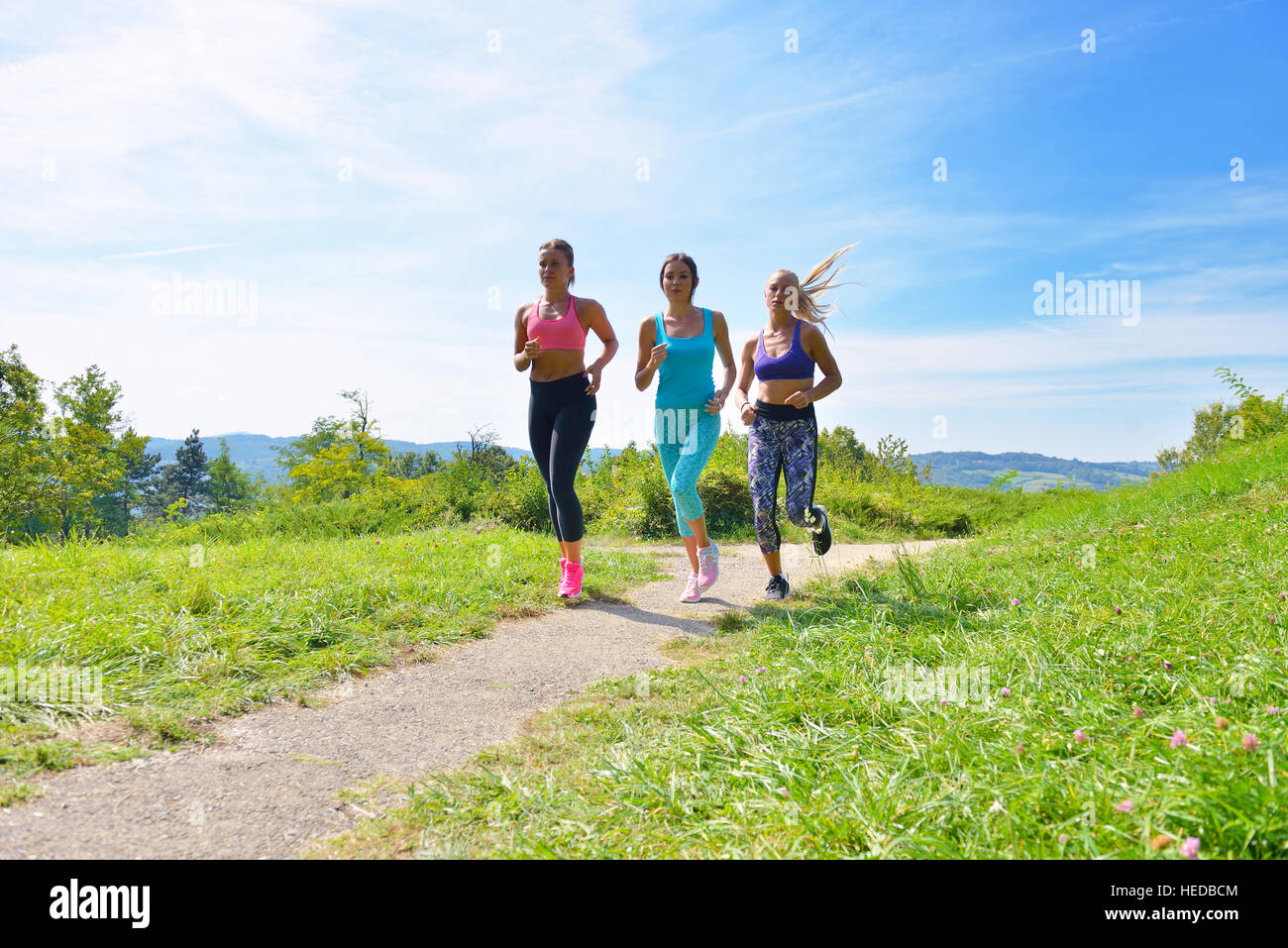 Three Female Joggers running together outdoors Stock Photo - Alamy