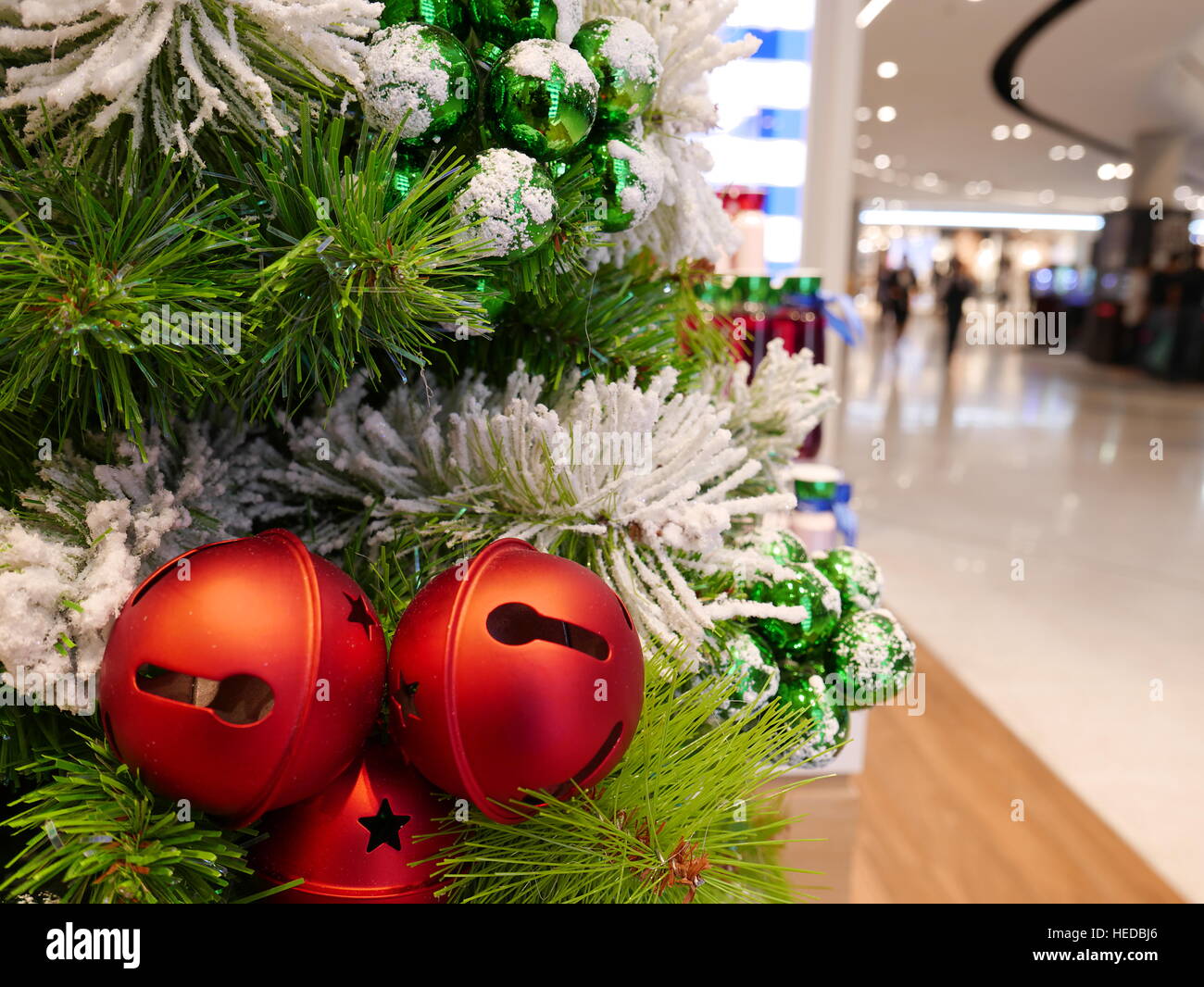 red small bell on christmas tree in department store Stock Photo - Alamy