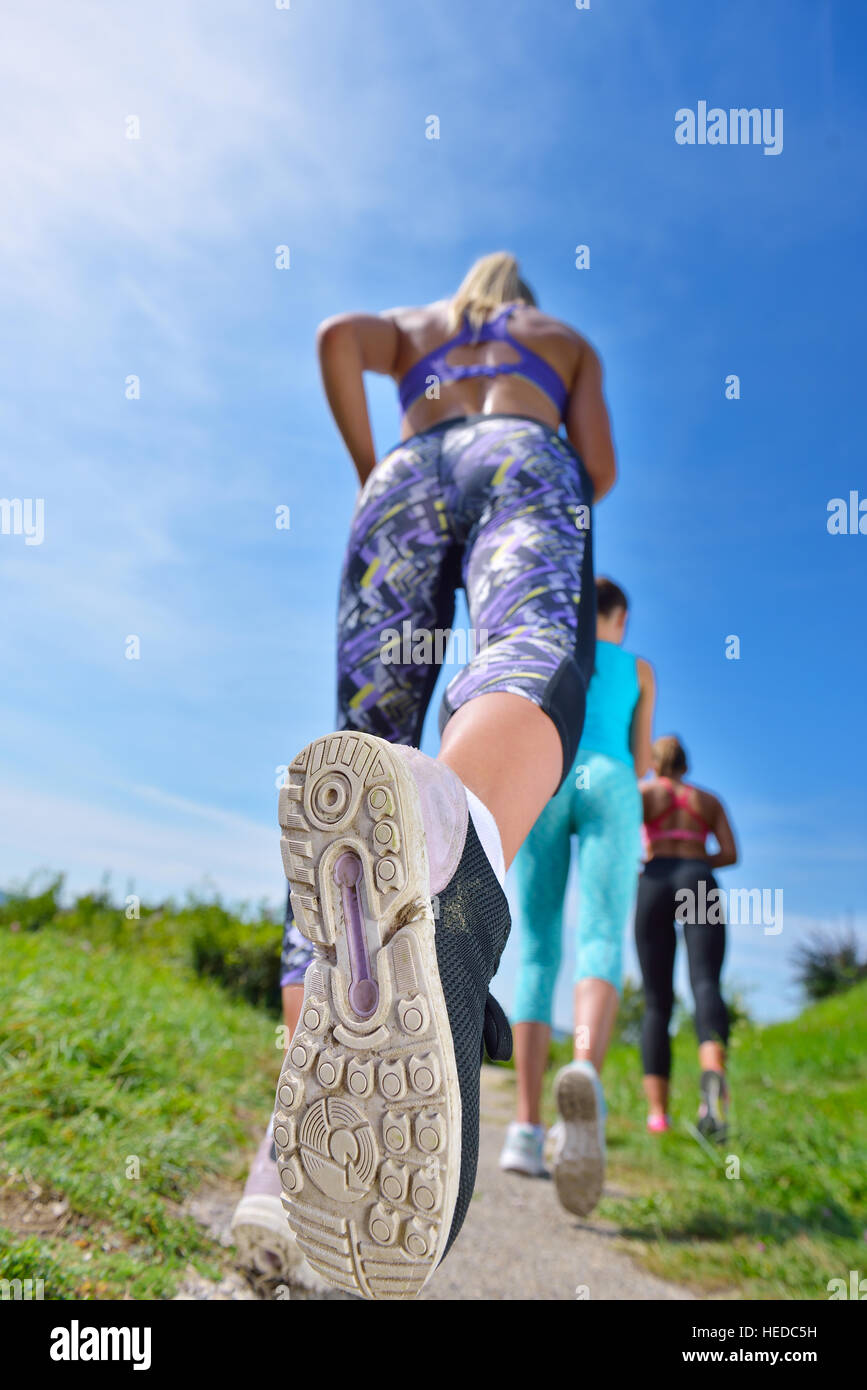 Three Female Joggers running together outdoors Stock Photo - Alamy