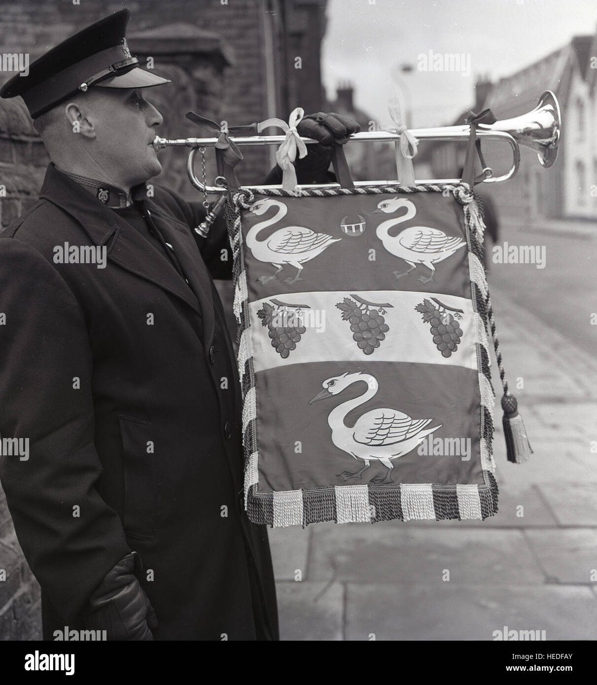 1960s, historical, military bandsman plays a bugle call on his trumpet ...
