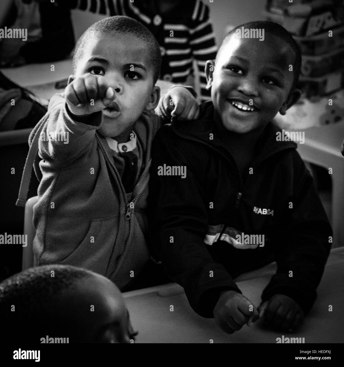 Two children strike a pose in a community supported school in a ...