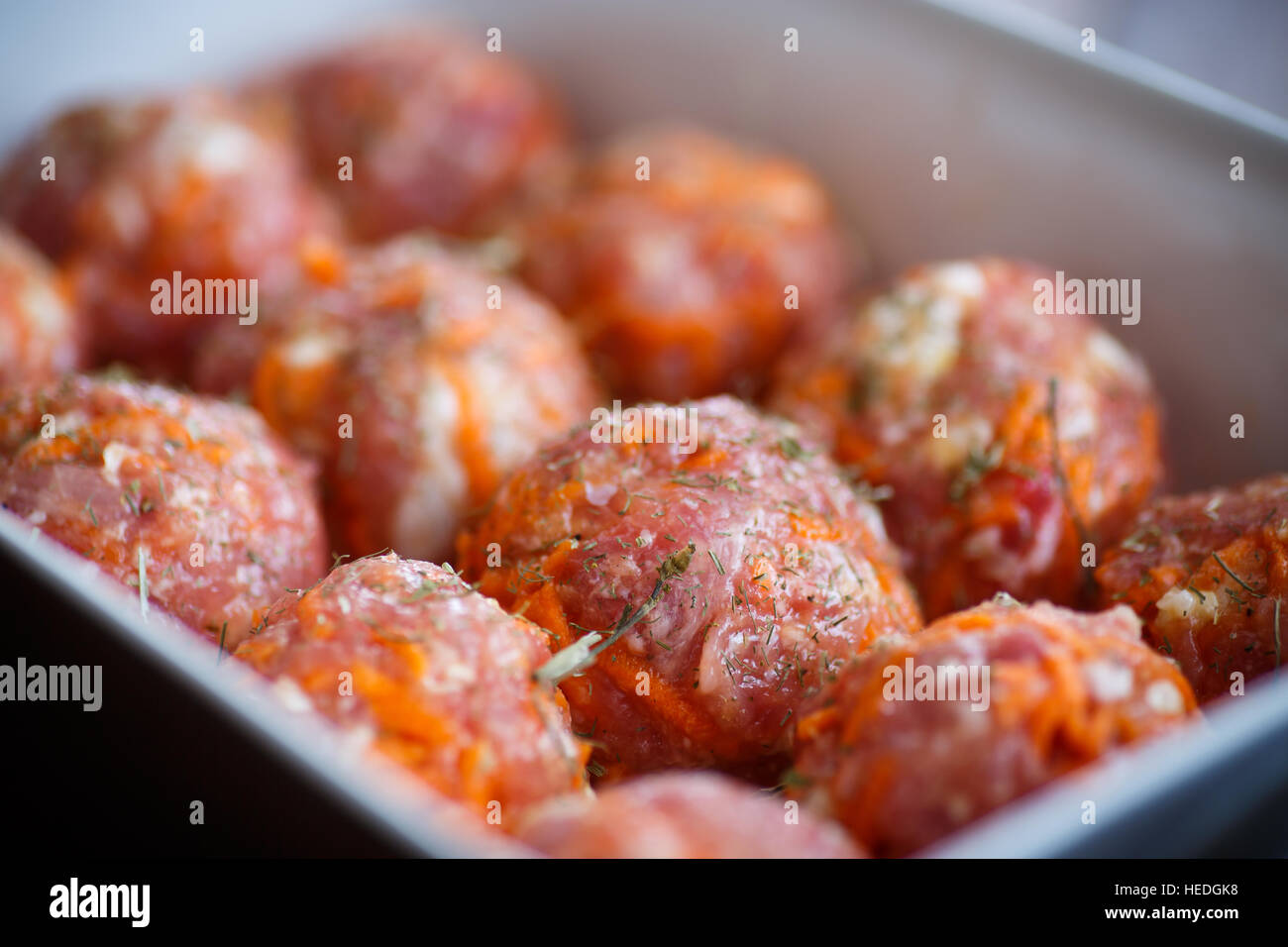 raw meatballs tangled meat with carrots Stock Photo - Alamy