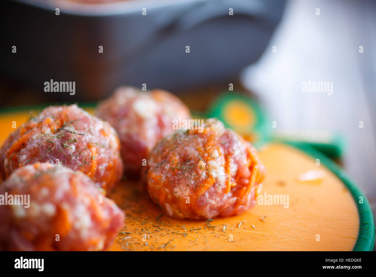 raw meatballs tangled meat with carrots Stock Photo - Alamy