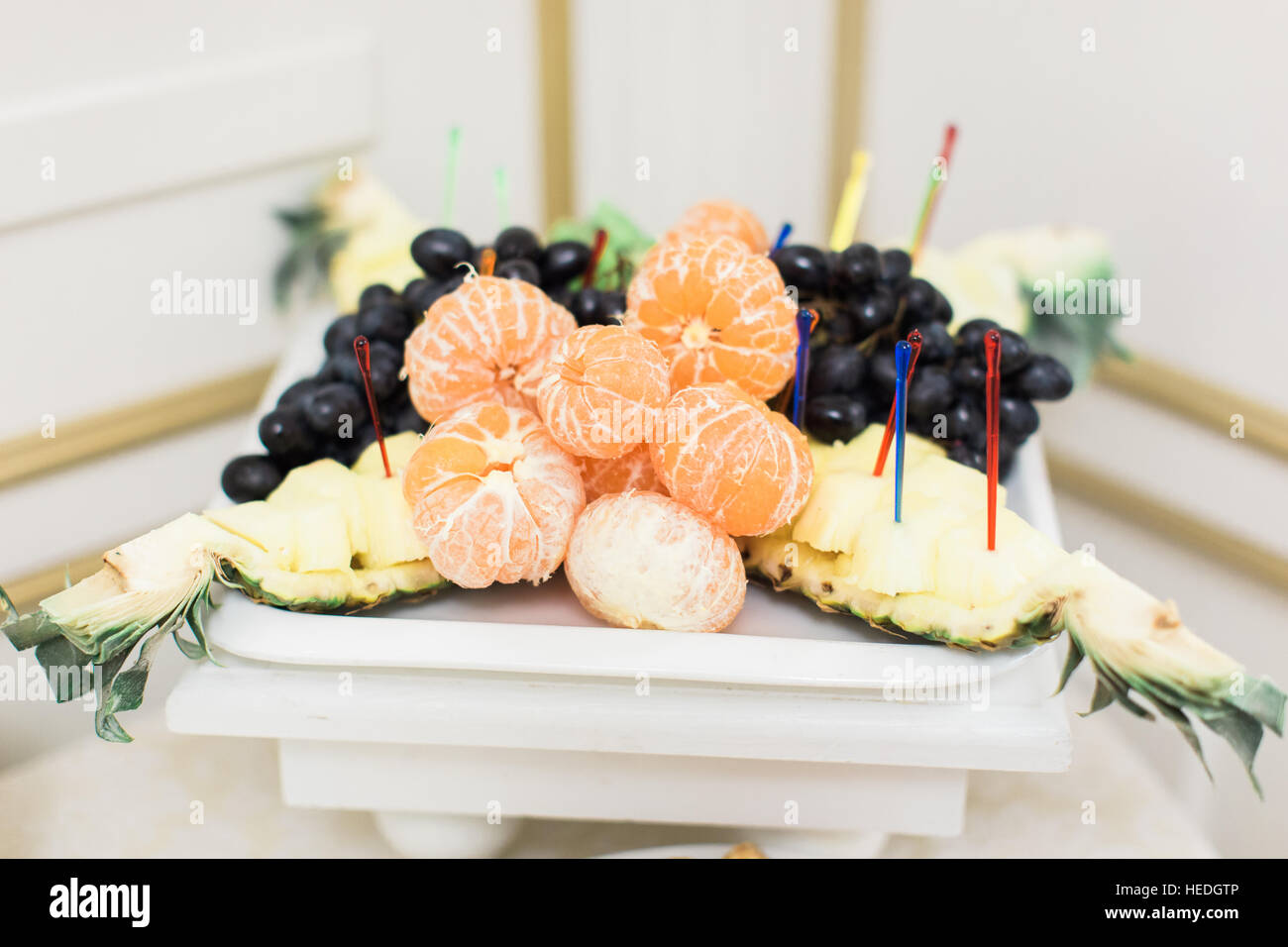 orange, mandarines, grape and pineapple fruits on reception Stock Photo ...