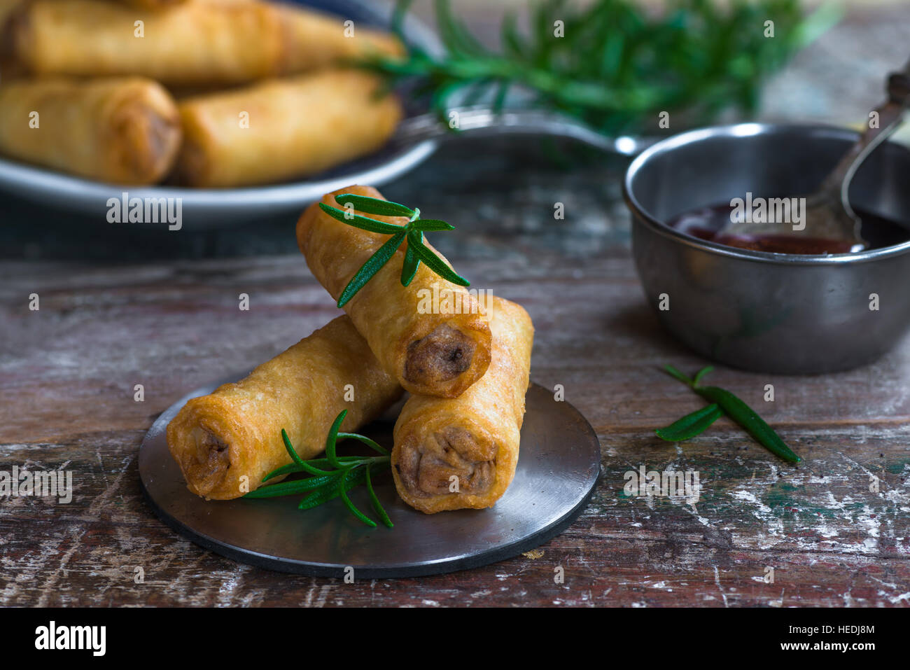 Fried Chinese duck spring rolls and sweet chili dip Stock Photo - Alamy