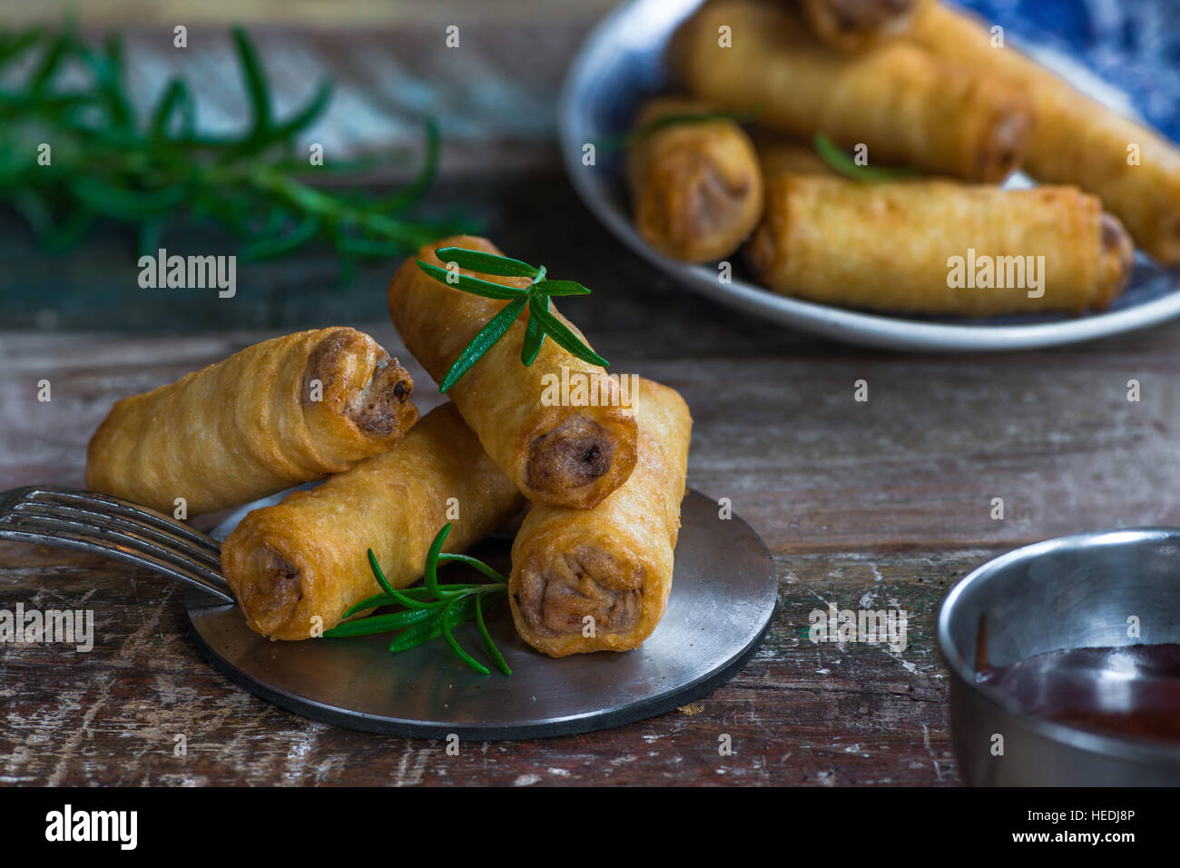 Fried Chinese duck spring rolls and sweet chili dip Stock Photo - Alamy