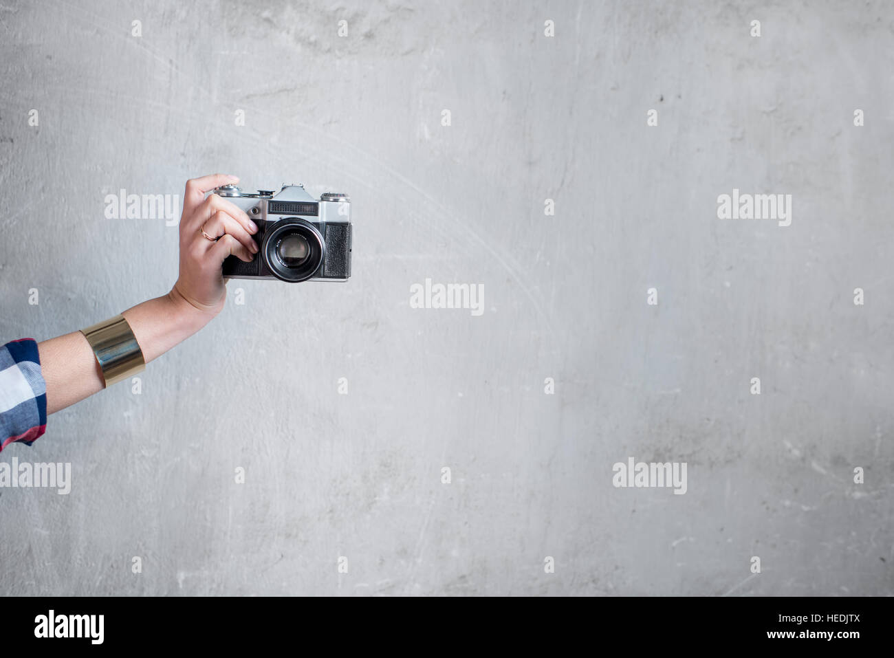 Photo camera on the gray wall background Stock Photo - Alamy
