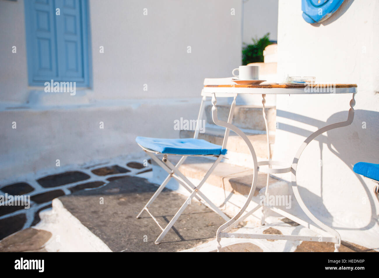 Beautiful cafe on a street of typical greek traditional village on ...