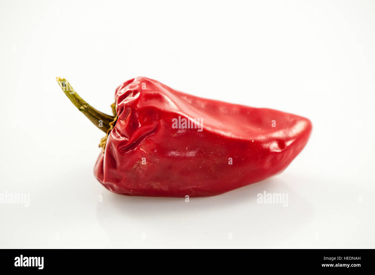 Red pepper overripe over a white background Stock Photo - Alamy