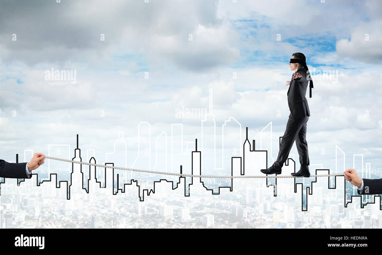 Business concept of risk support and assistance with man balancing on ...