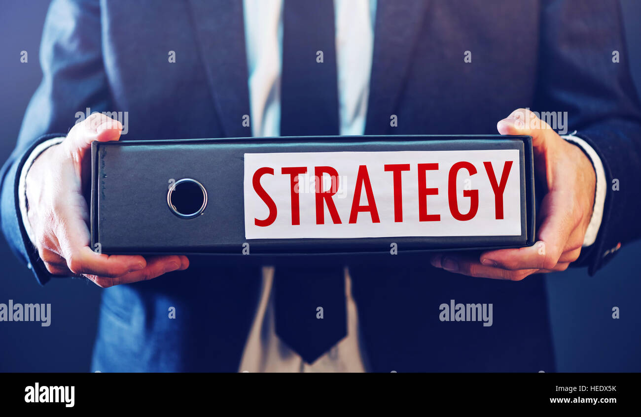 Business strategy, businessman with document ring binder in the office ...