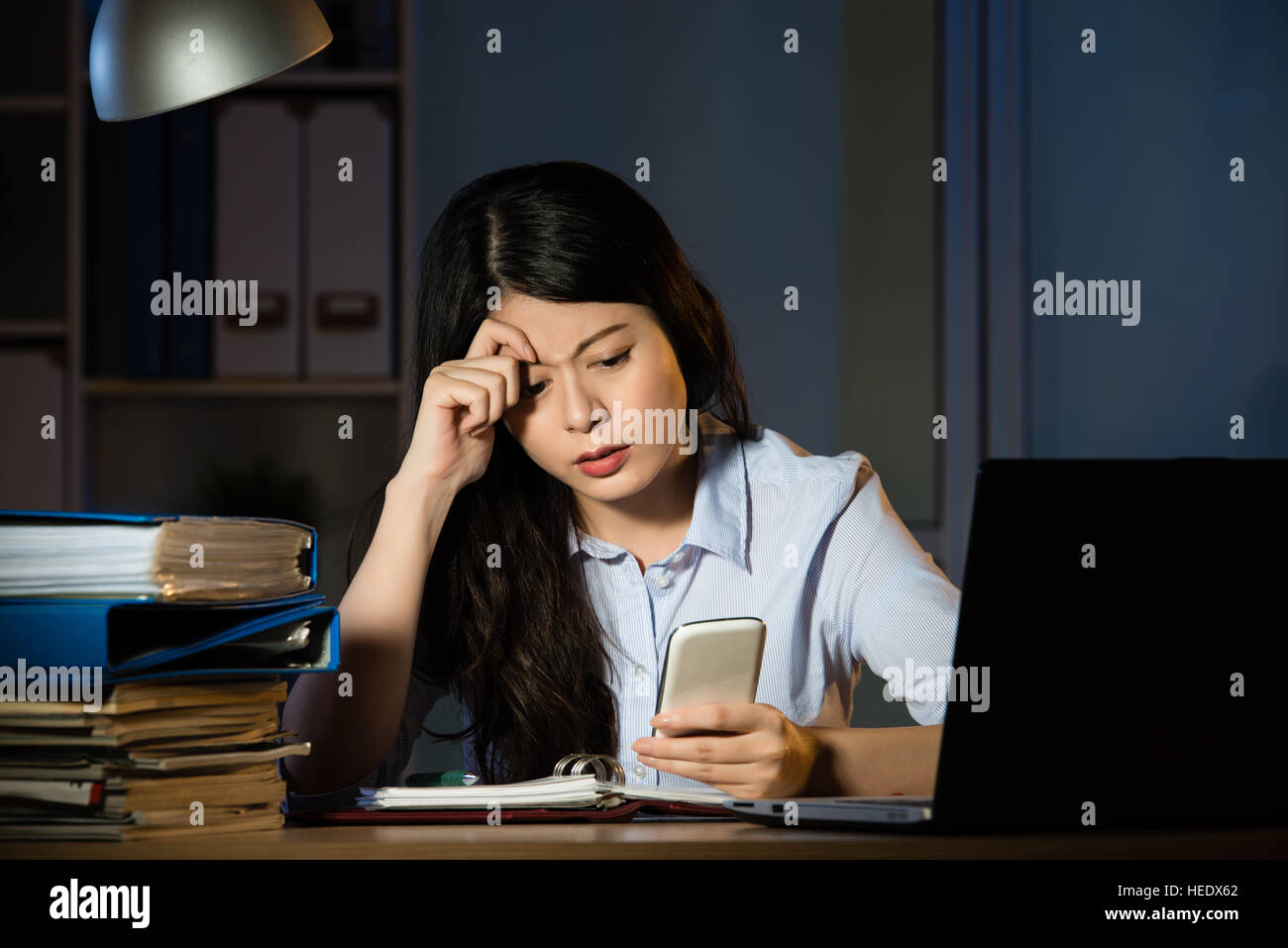 asian business woman text message by smartphone working overtime late ...
