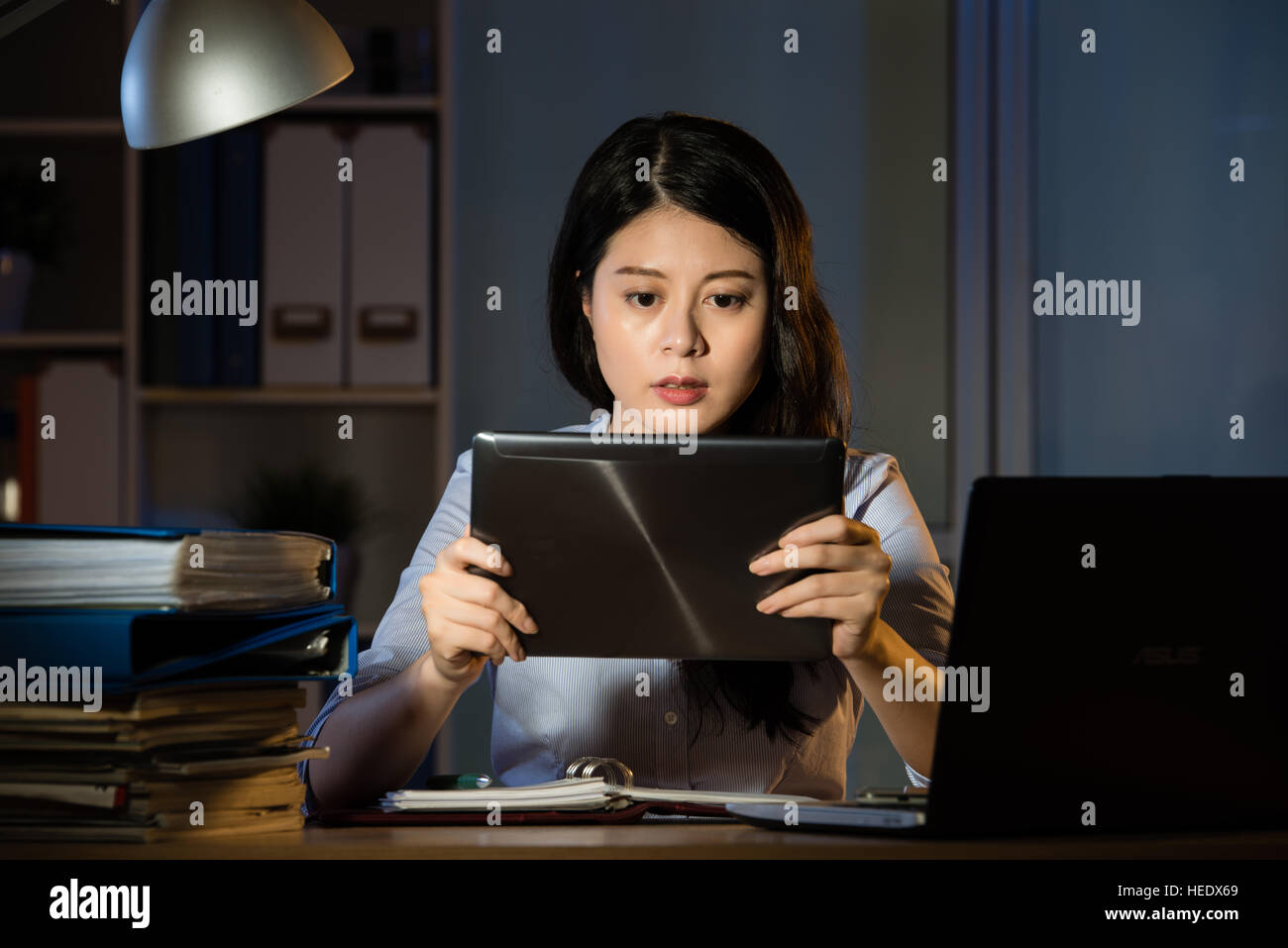 asian business woman touch screen on digital tablet working overtime ...
