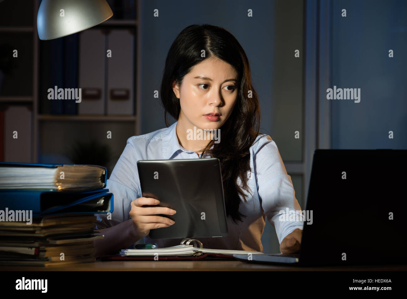 asian business woman touch screen on digital tablet working overtime ...