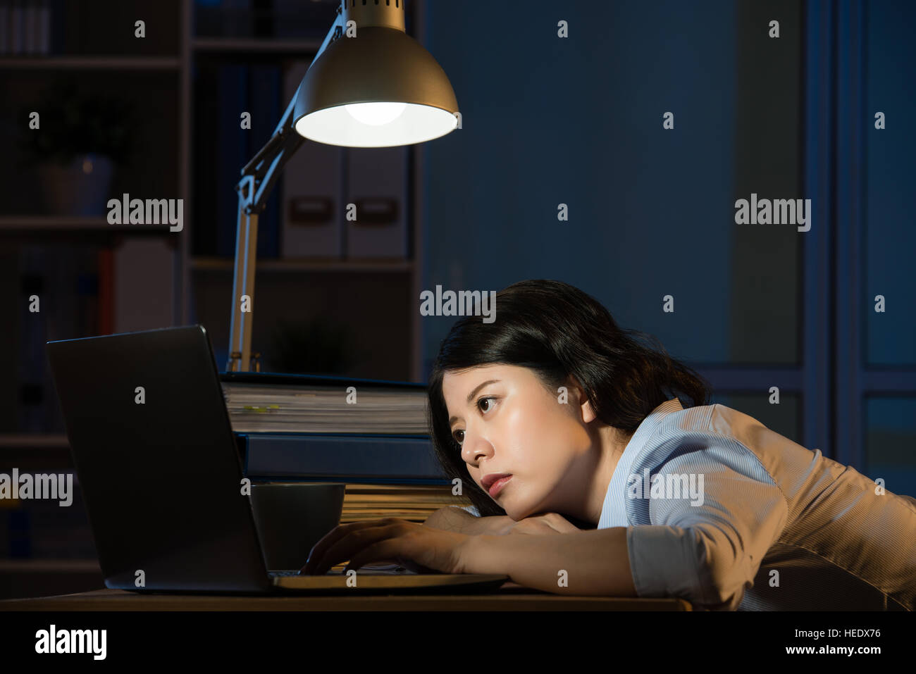 asian business woman sitting at desk sleepy working overtime late night ...