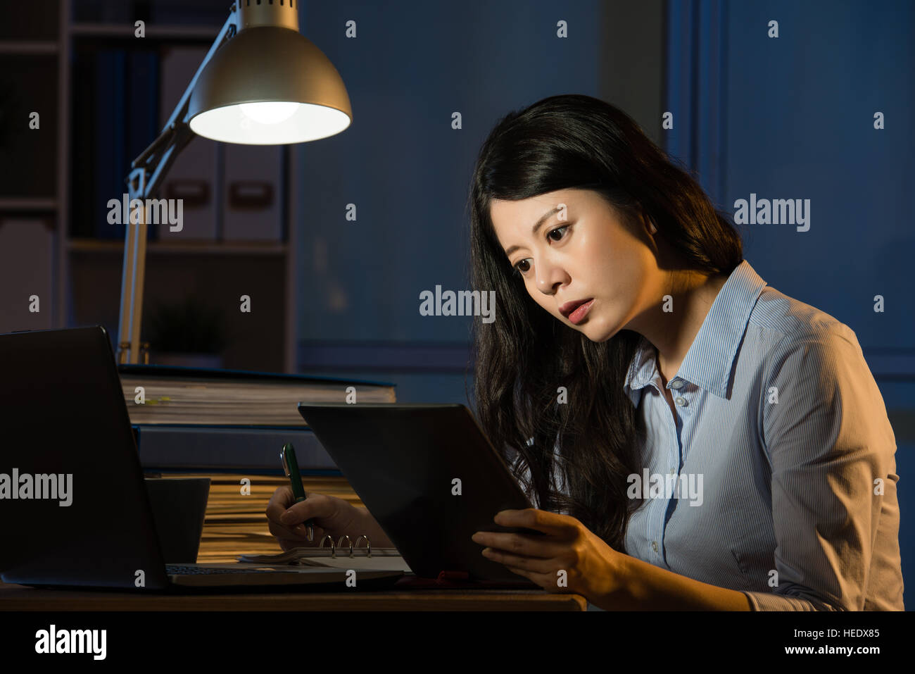 asian business woman touch screen on digital tablet working overtime ...