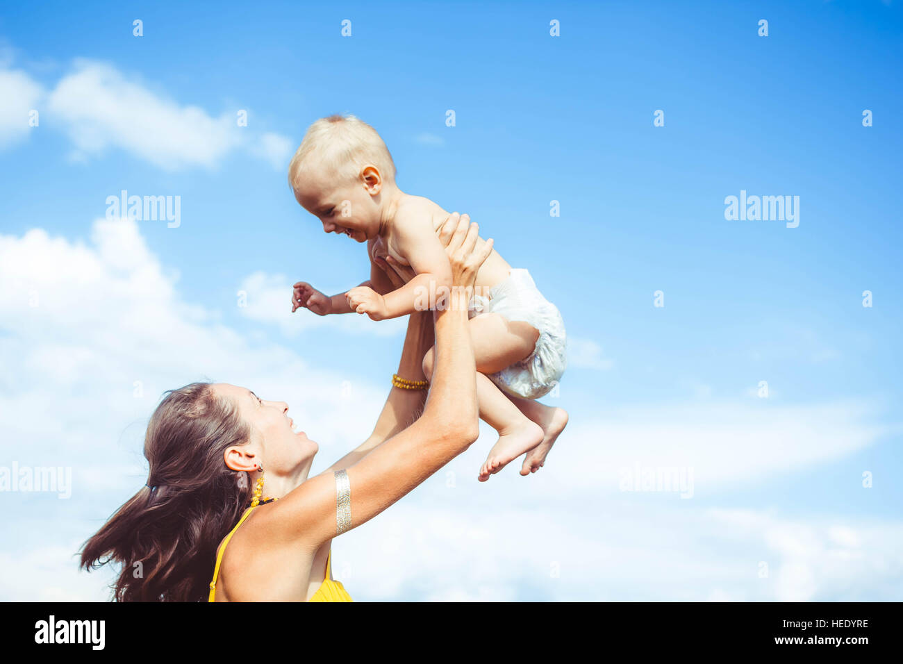 the mother raises the child Stock Photo - Alamy