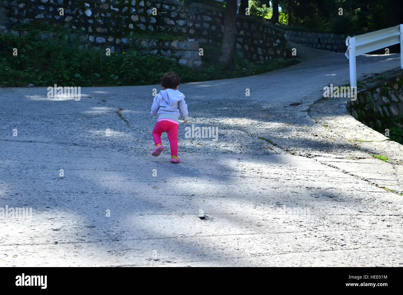 A girl running on a raod Stock Photo - Alamy